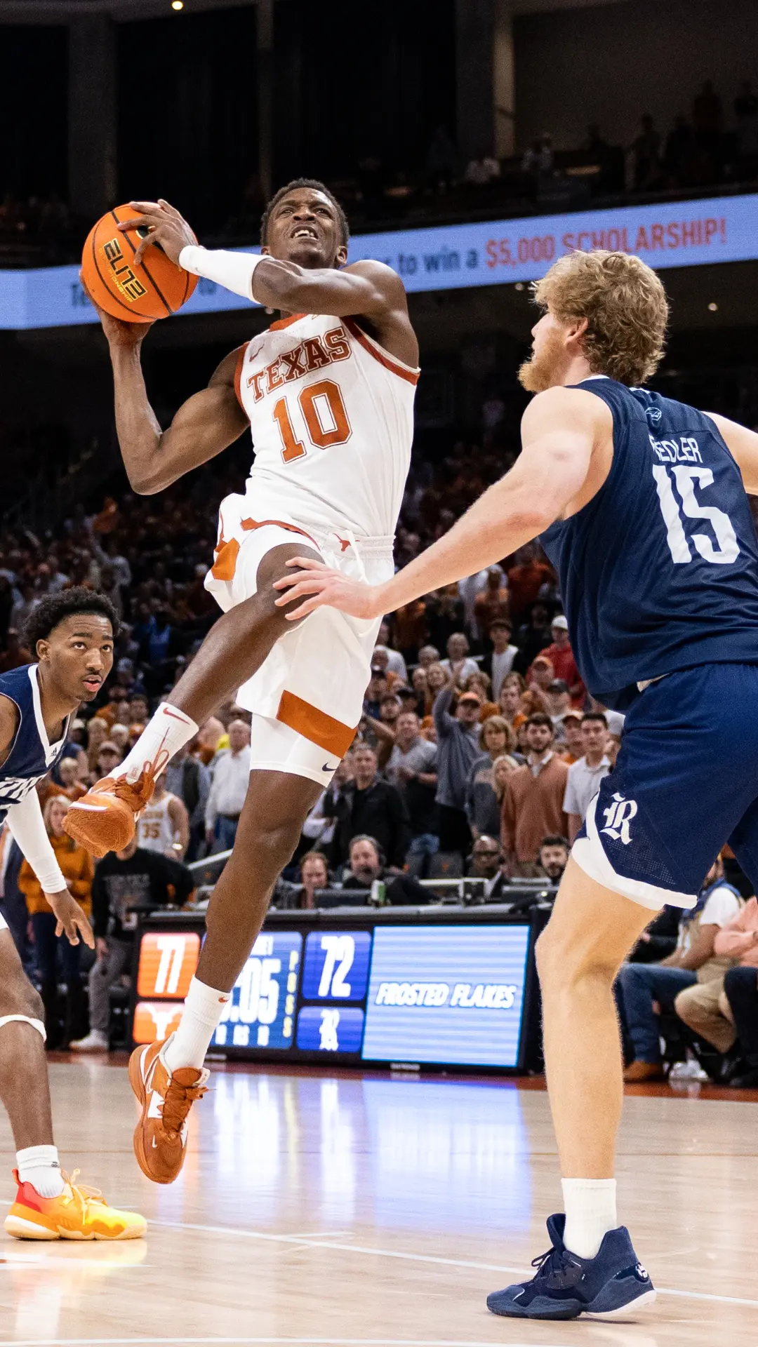Jabari Rice goes up for the shot in the paint and is fouled on the knee ...